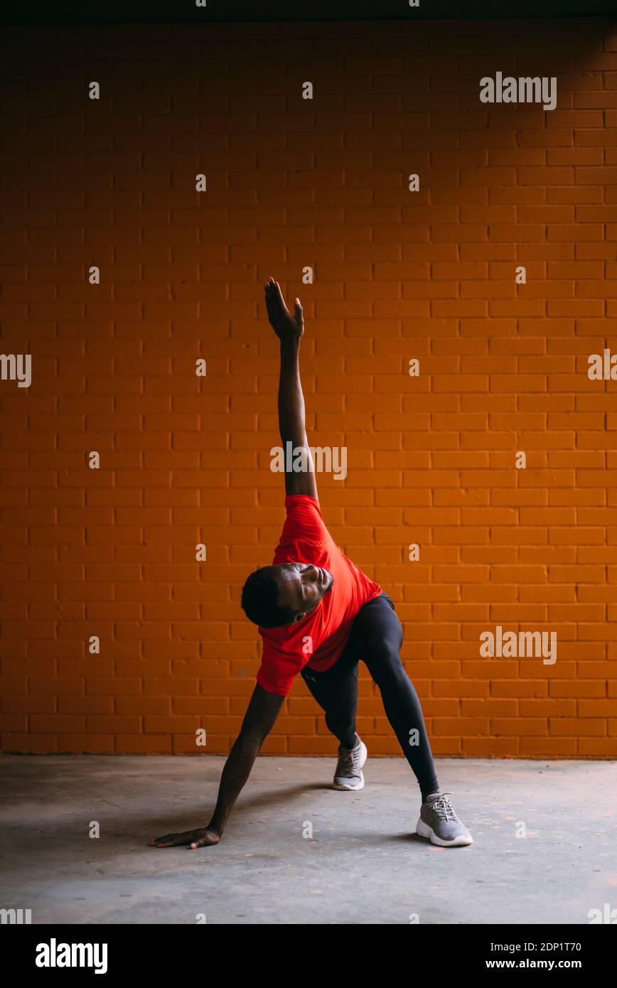 Young sportive man doing fitness exercise outdoors Stock Photo - Alamy