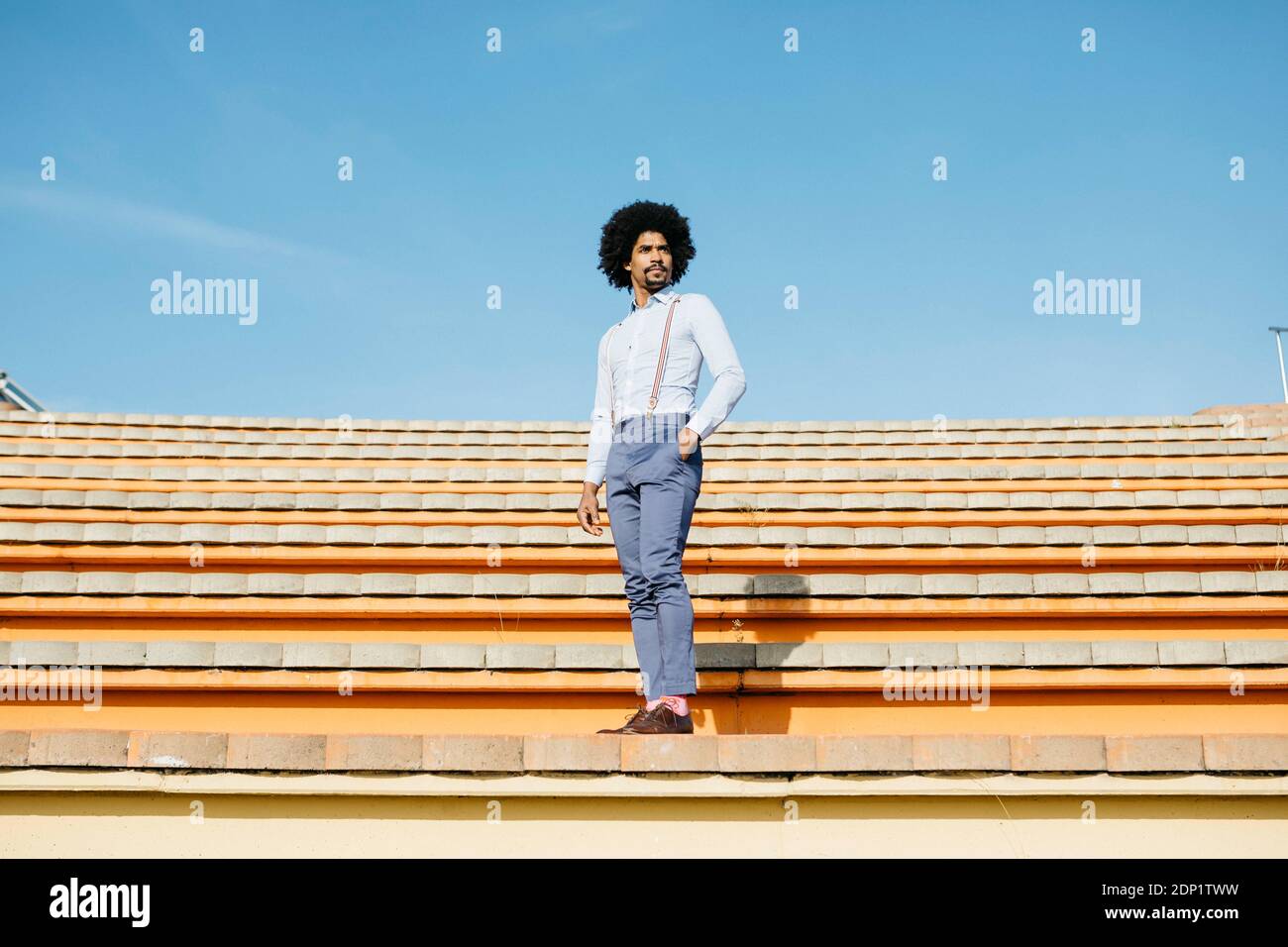 Stylish man standing on stairs Stock Photo - Alamy