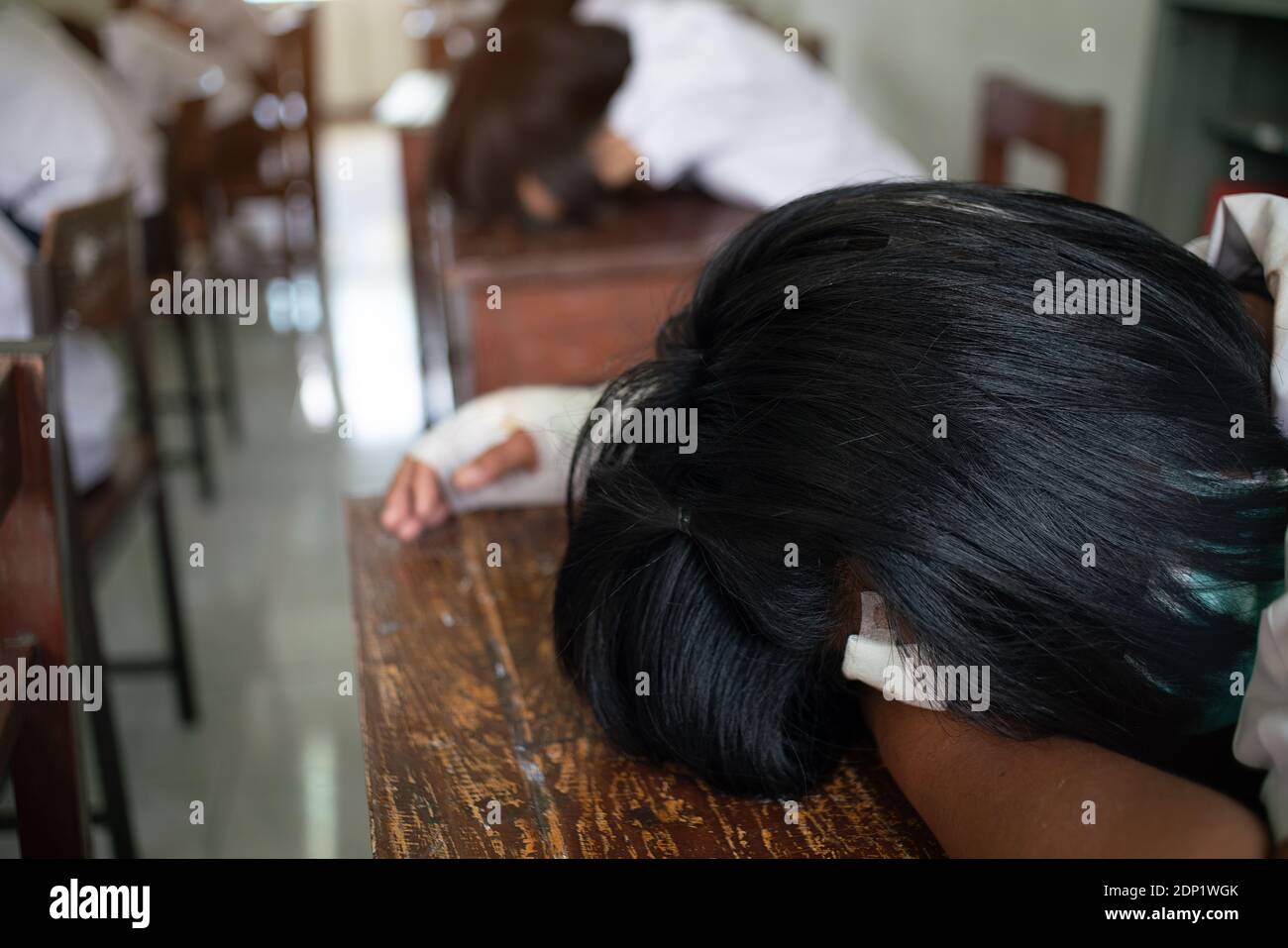 Injured Students taking exam with stress in school classroom Stock ...