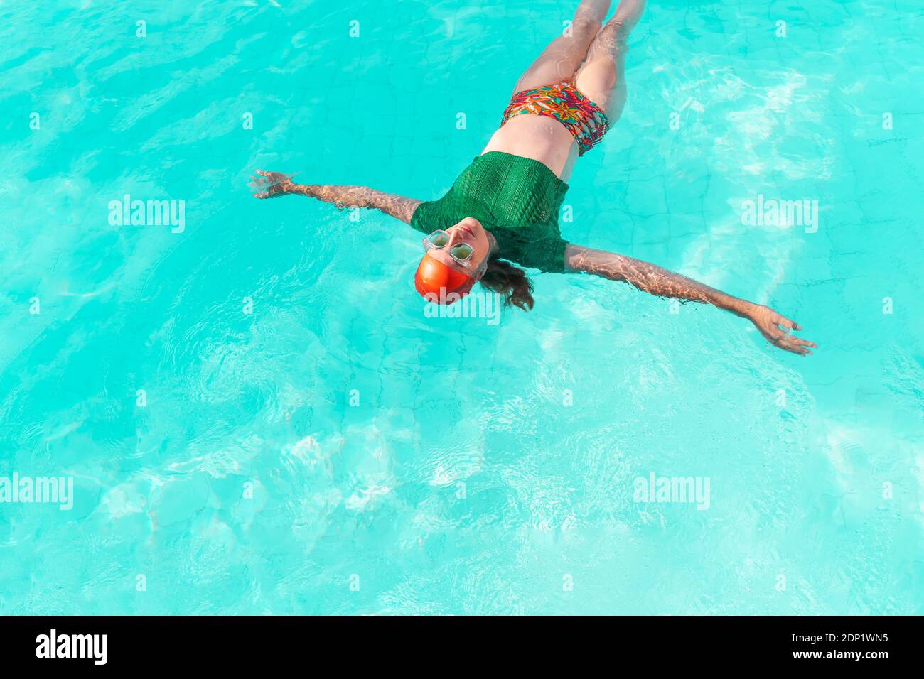Woman floating on water in swimming pool Stock Photo - Alamy