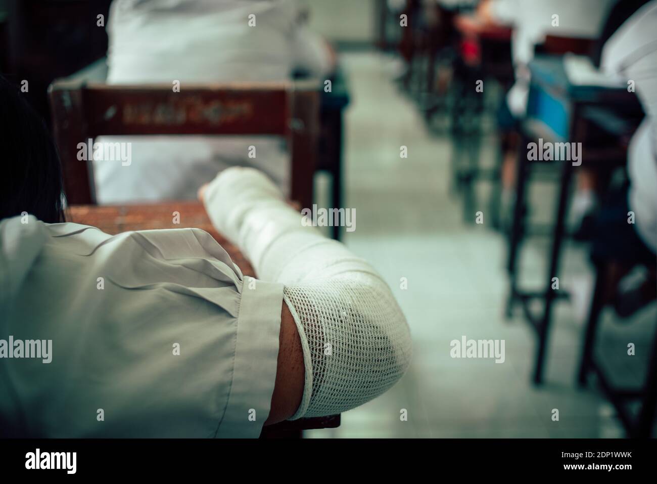 Injured Students taking exam with stress in school classroom Stock ...