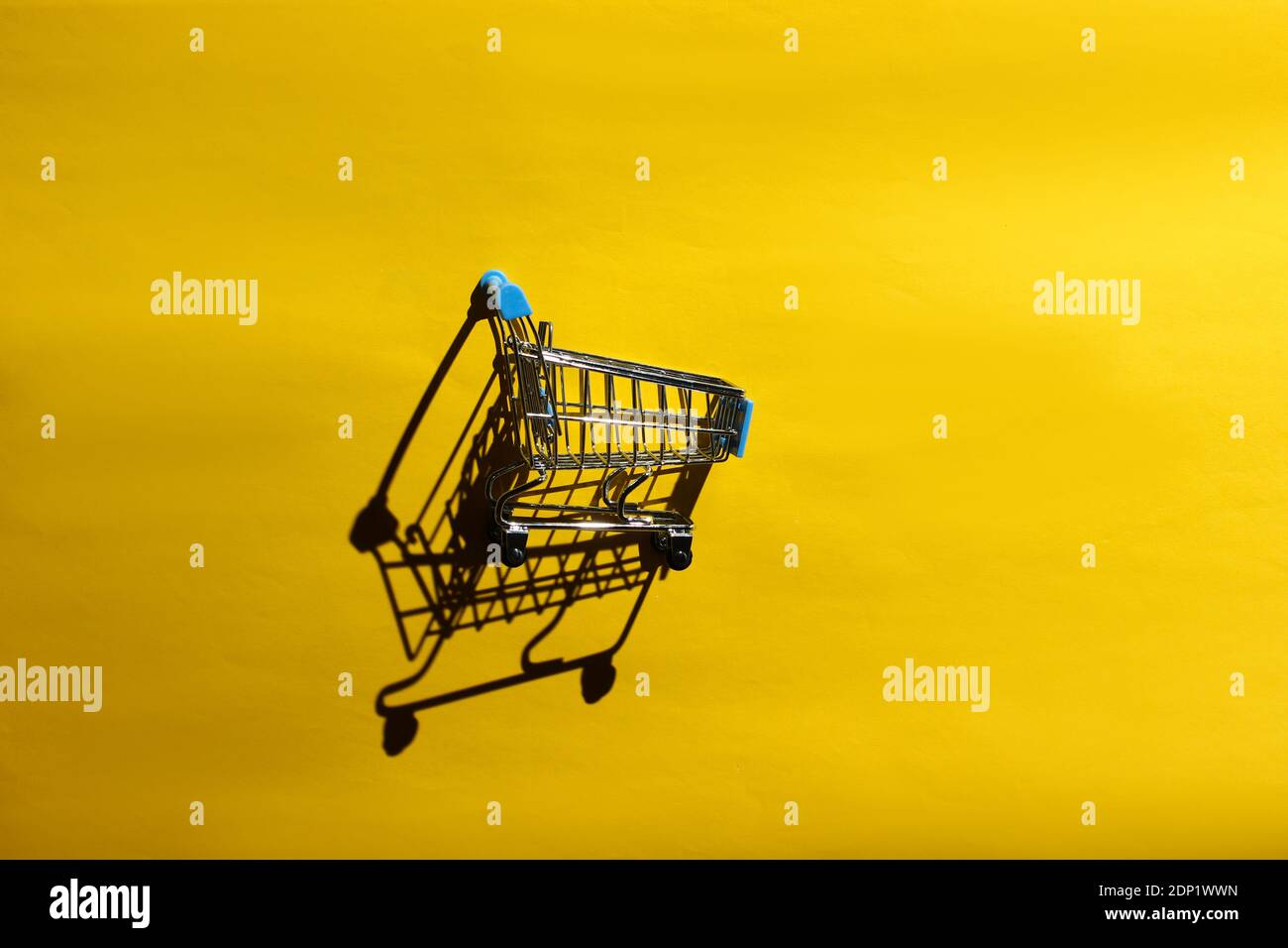 Mini shopping trolley for shopping on yellow background, consumer ...