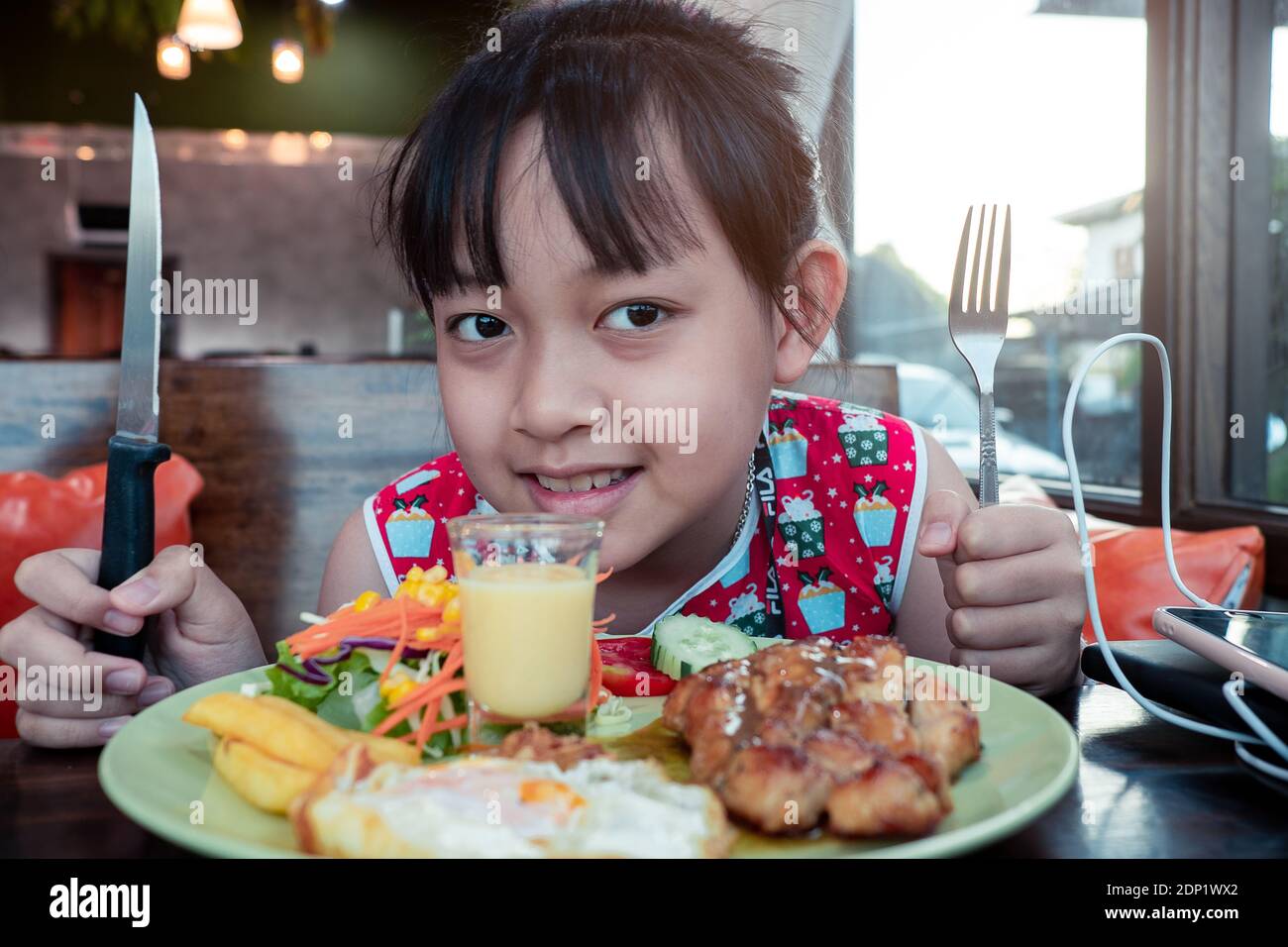 Child eating steak and salad hi-res stock photography and images - Alamy