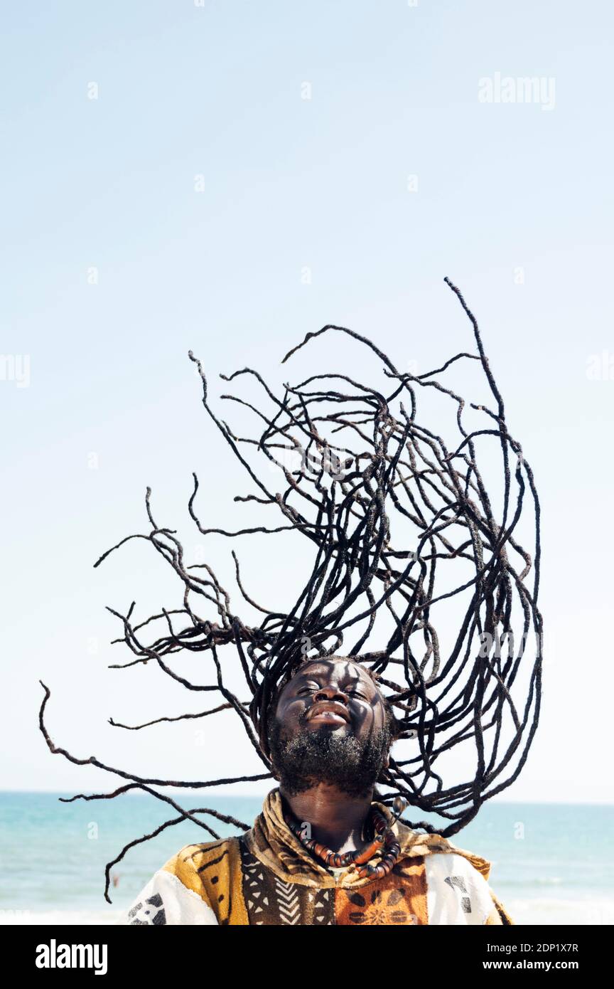 Rastafari man tossing his dreadlocks on the beach Stock Photo - Alamy