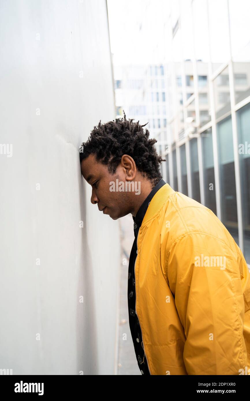 Man leaning with forehead on a wall Stock Photo - Alamy