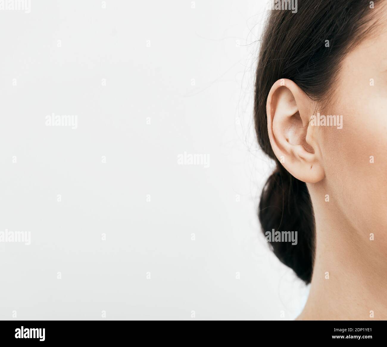 Hearing concept. Female ear close up on white background Stock Photo ...