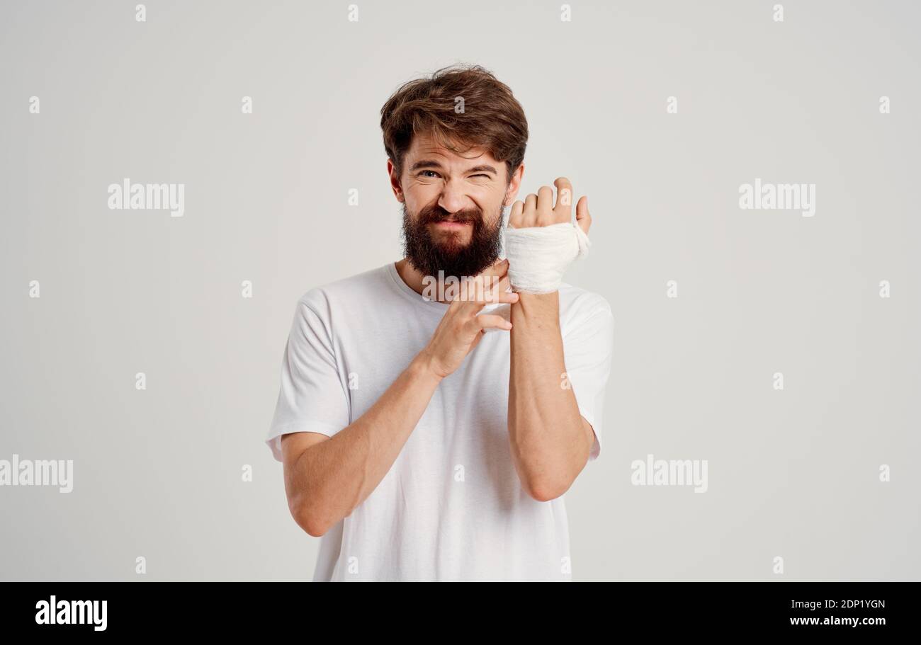 bearded man on patient bandaged hand health problems hospital medicine ...