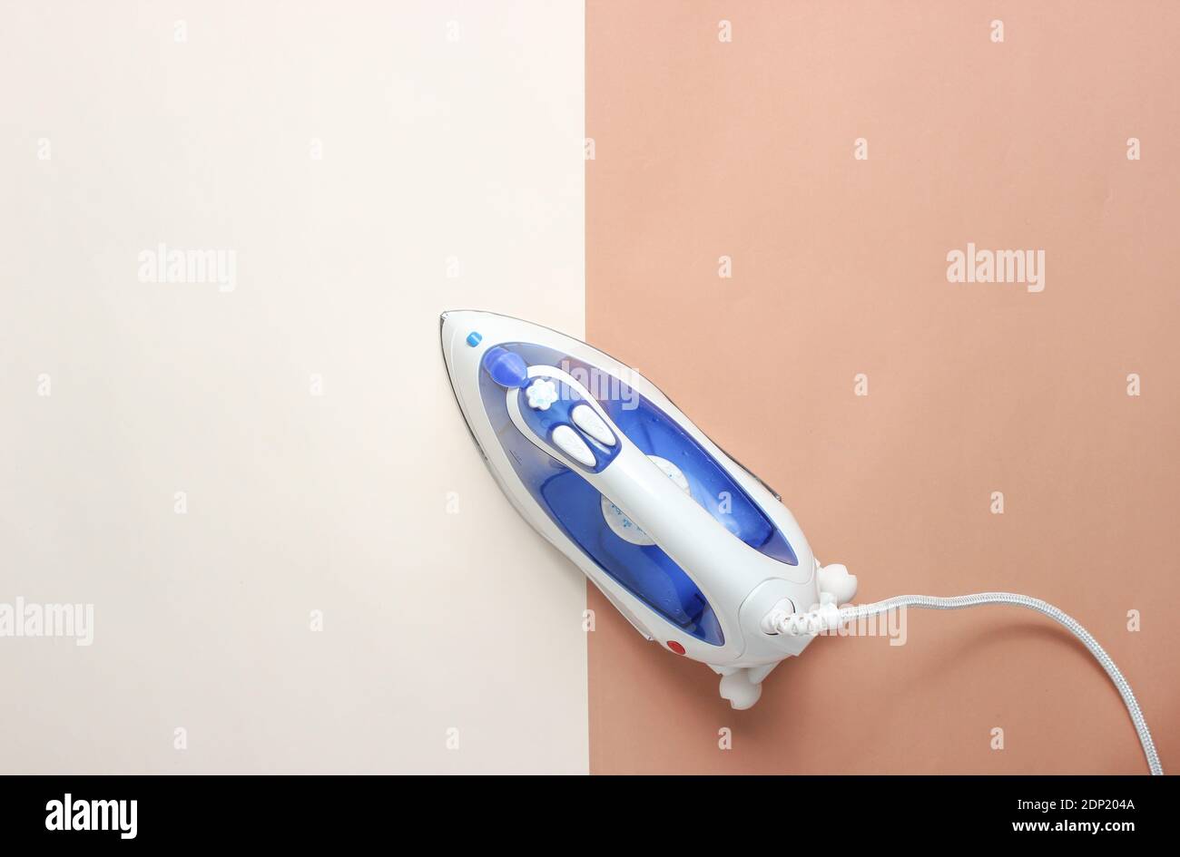 Iron for ironing on a colored paper background. Top view, creative ...