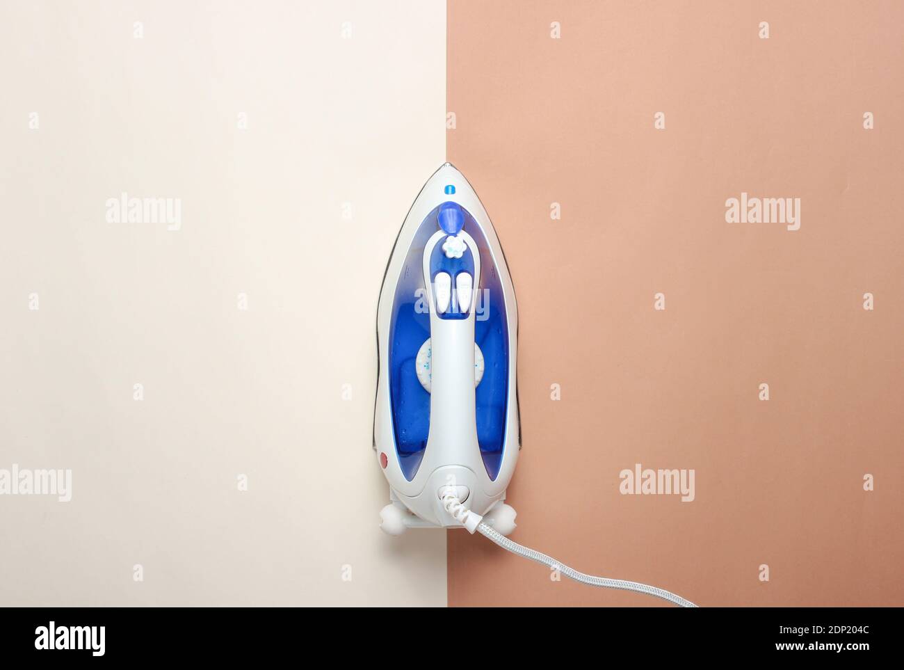 Iron for ironing on a colored paper background. Top view, creative ...