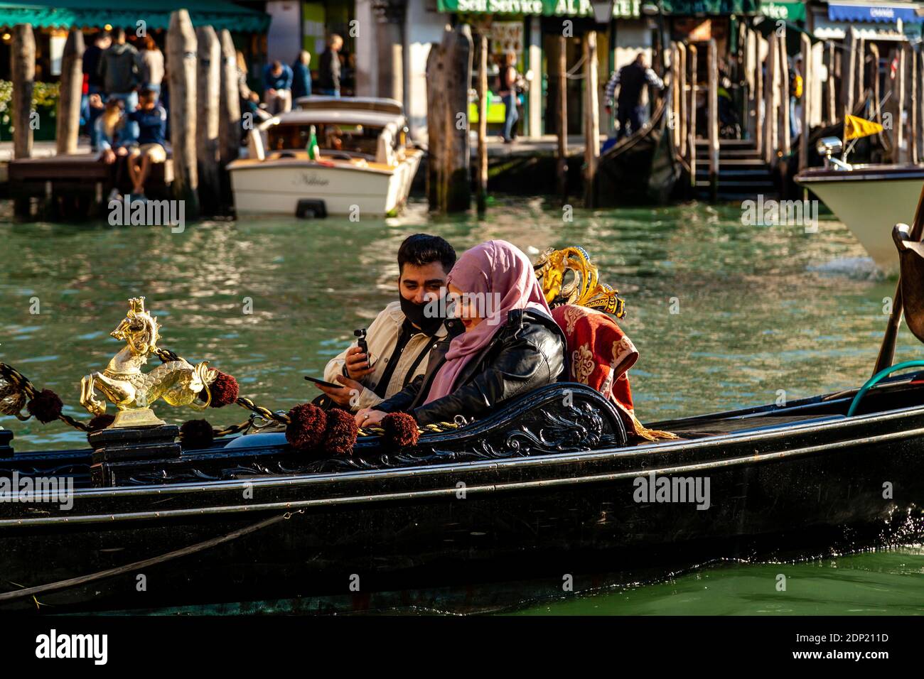 A Young Couple Take A Gondola Ride On The Grand Canal Venice Italy