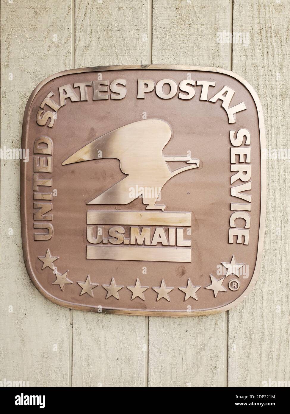 Close-up shot of the United States Postal Service sign featuring an ...