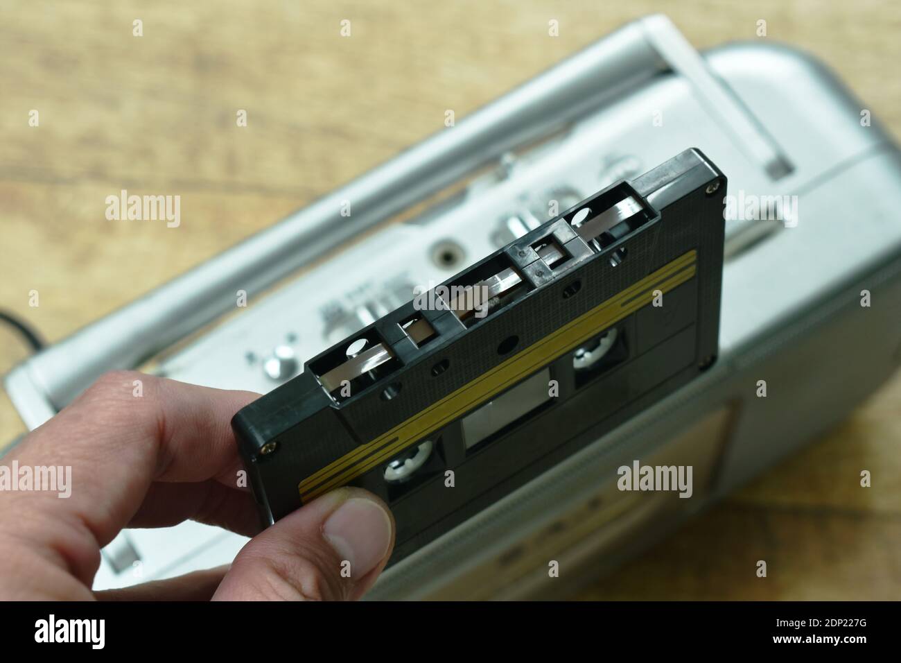 hand holding black cassette tape with radio background Stock Photo - Alamy