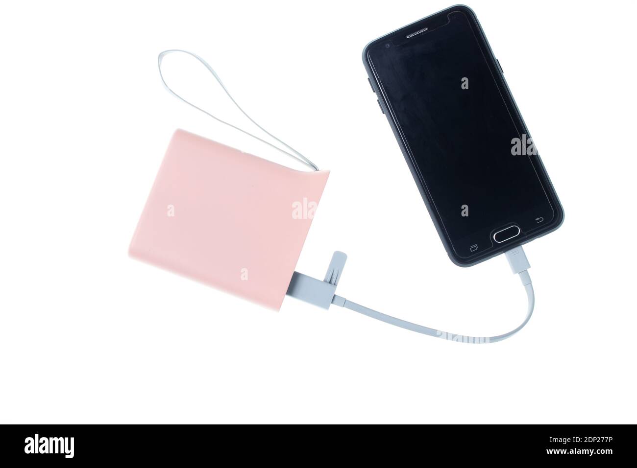 Modern smartphone charging from power bank isolated on white background ...