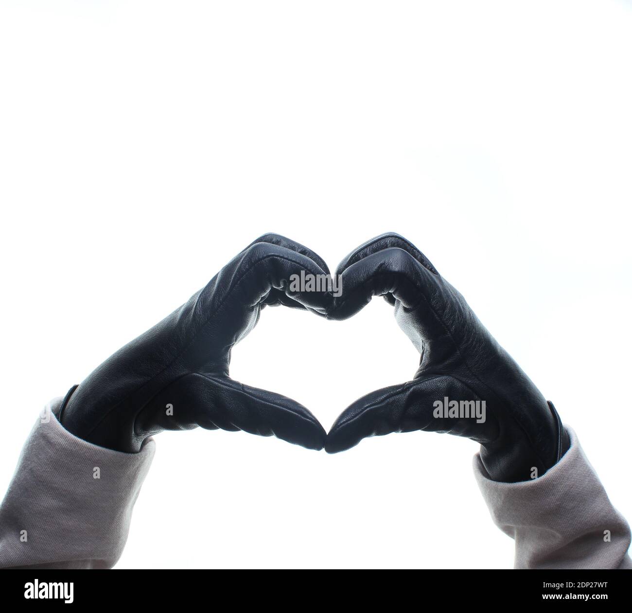 Female hands with leather gloves show a heart sign with fingers ...