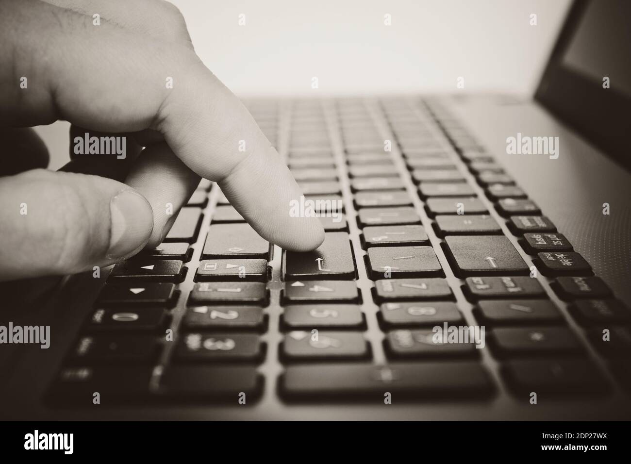 closeup of a finger pressing laptop keyboard Stock Photo - Alamy