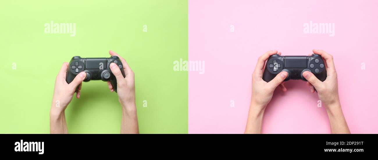 Two persons compete in the video game on the gamepads. Top view ...