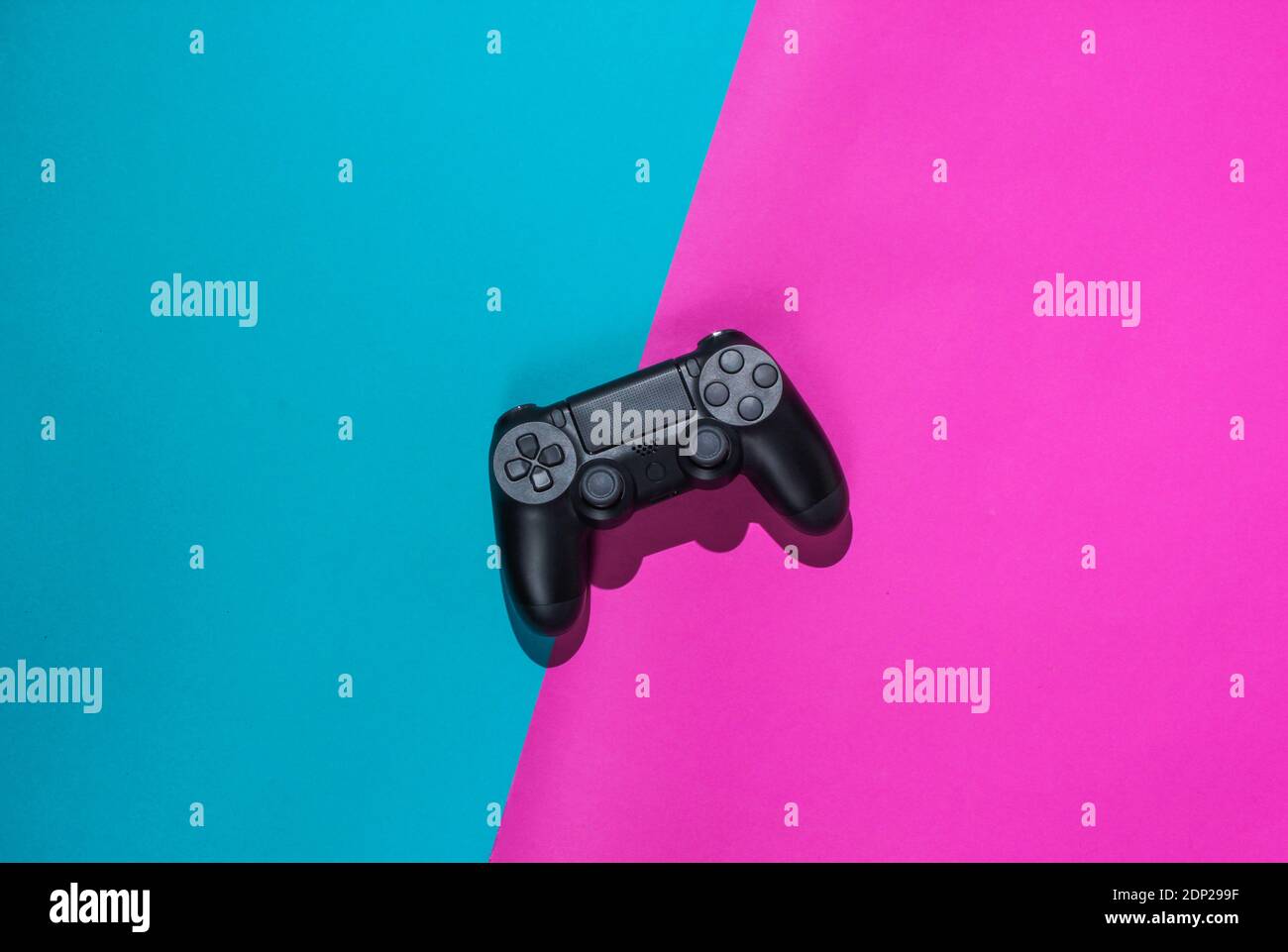 Gamepads on a colored paper background. Top view. Minimalism. Hard ...