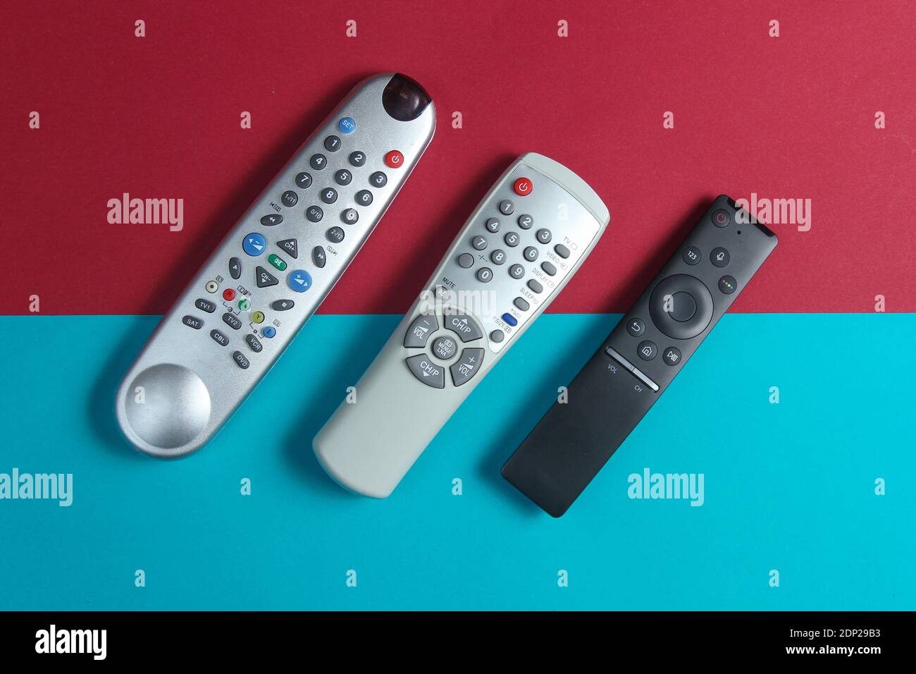 Different TV remotes on a red-blue background. Top view Stock Photo - Alamy