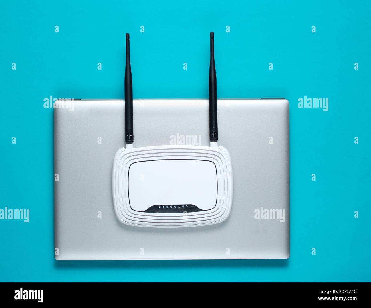 Wi fi router, laptop on a blue background. Top view Stock Photo - Alamy