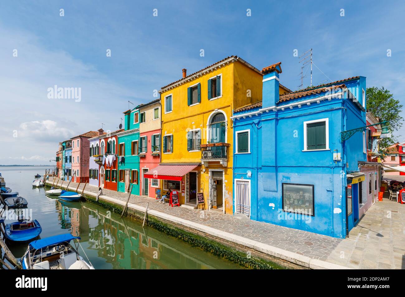 Brightly coloured canal-side painted buildings in Burano, a small ...