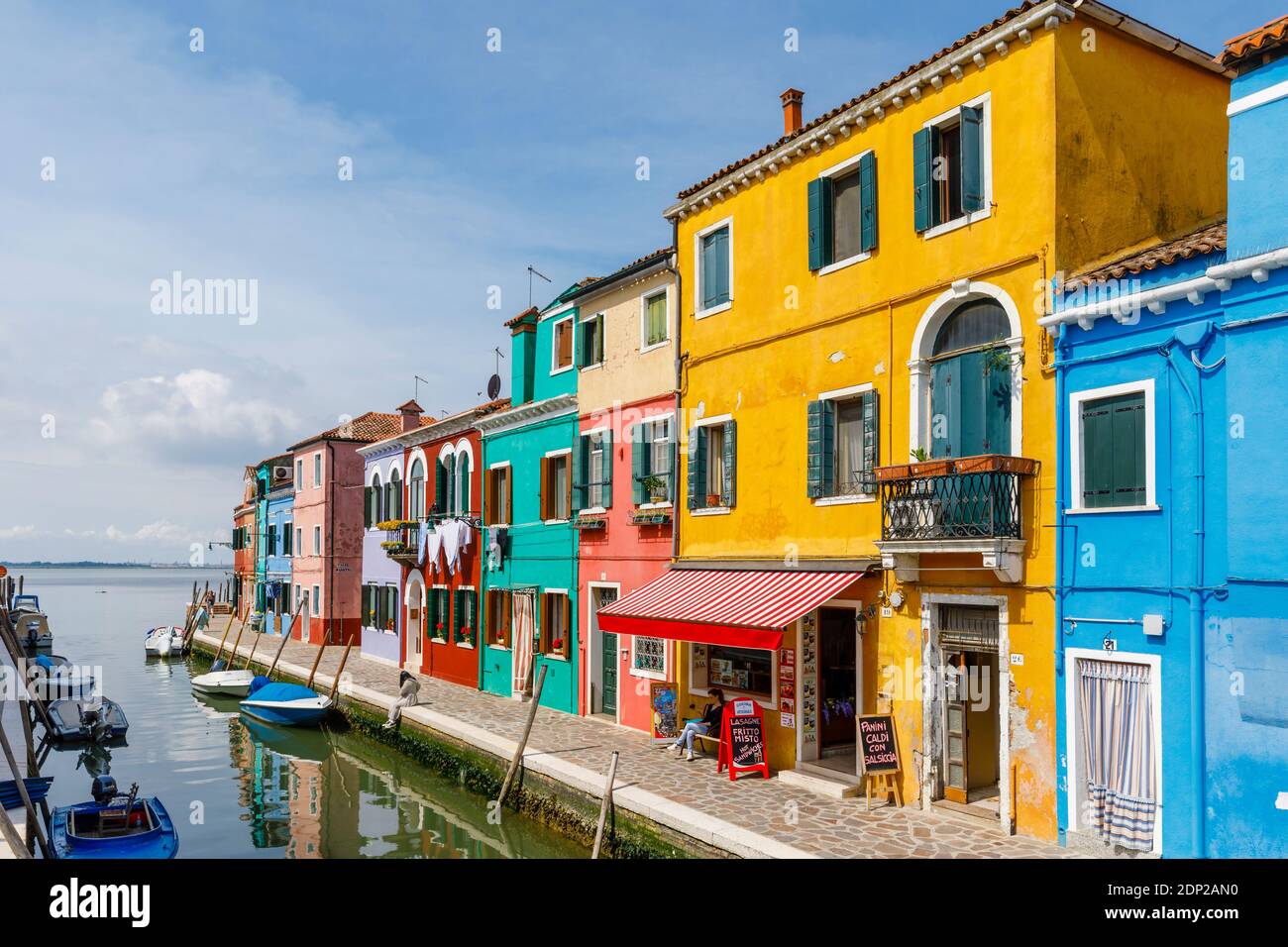 Brightly coloured canal-side painted buildings in Burano, a small ...