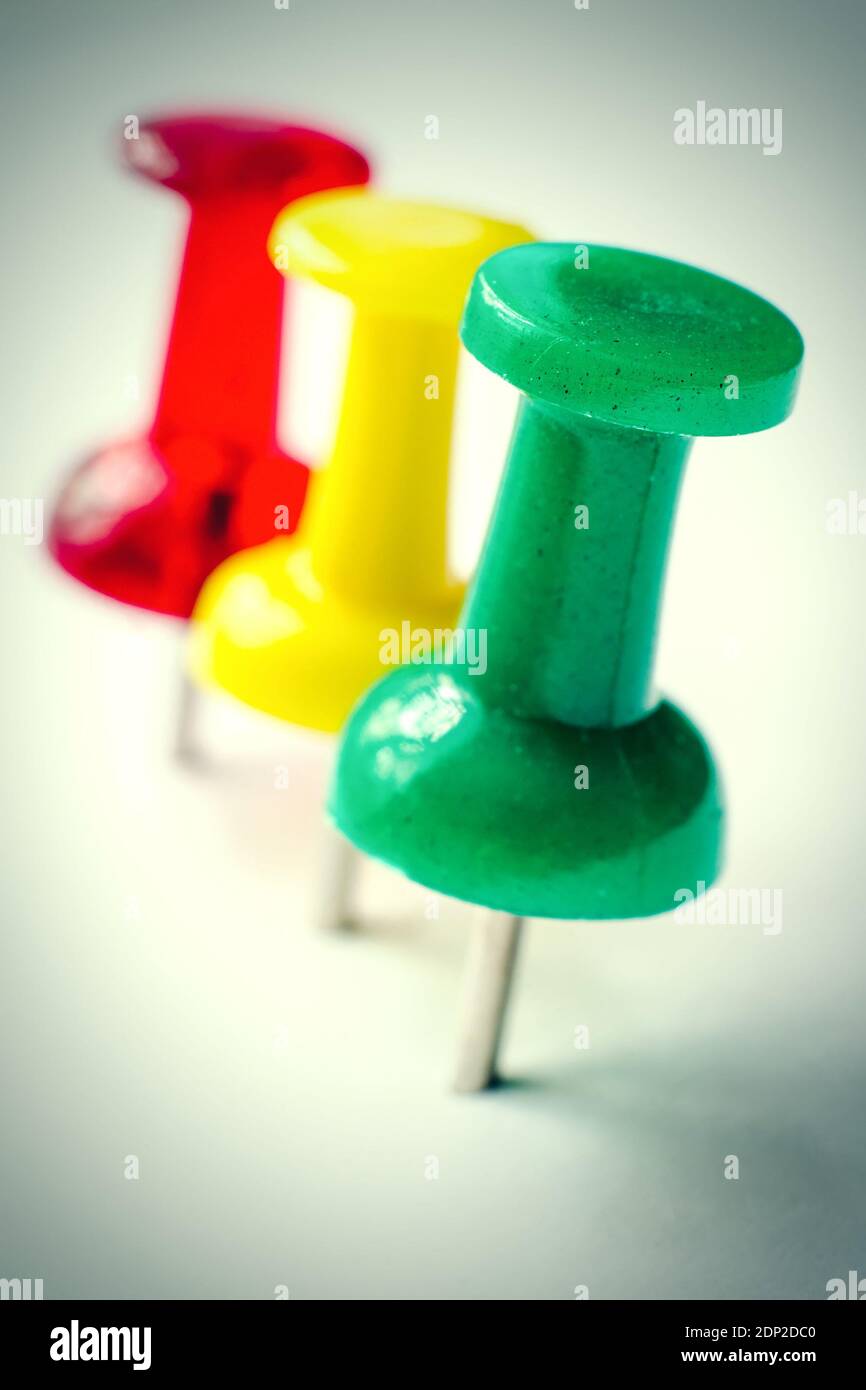 three pins in a board macro Stock Photo - Alamy