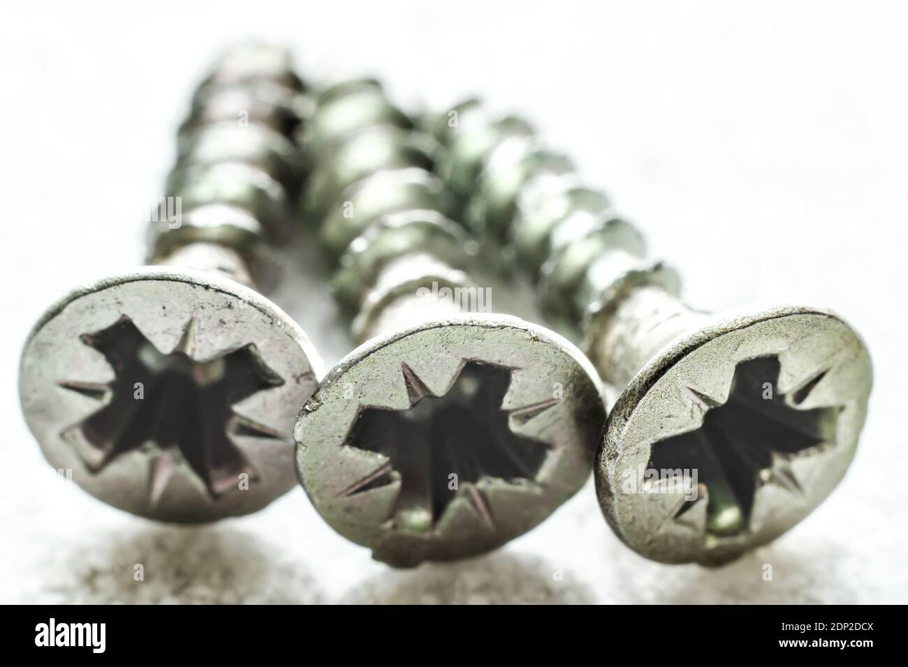 three metal screws macro closeup Stock Photo - Alamy