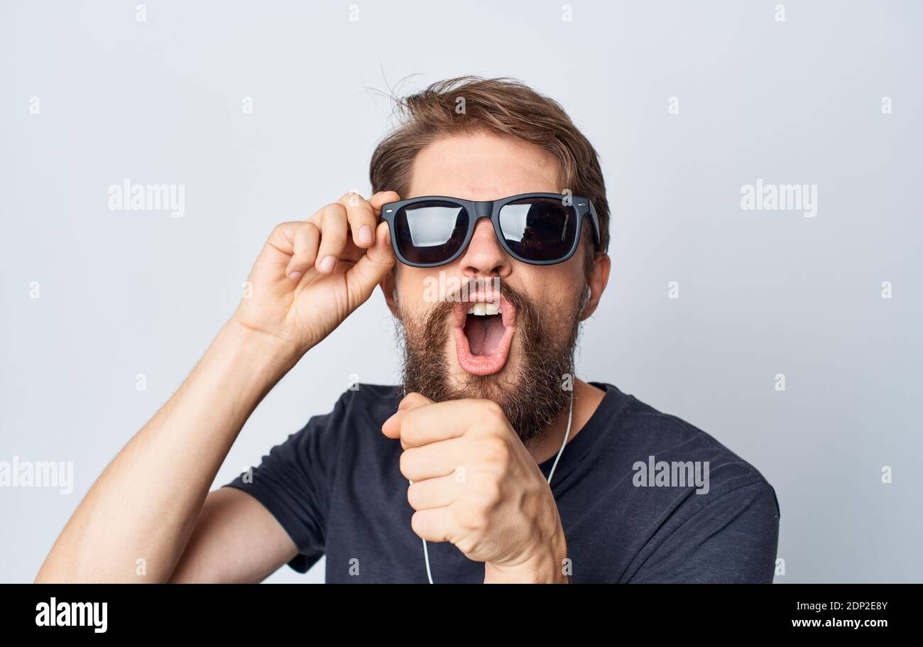 a man with sunglasses singing into an imaginary microphone music ...