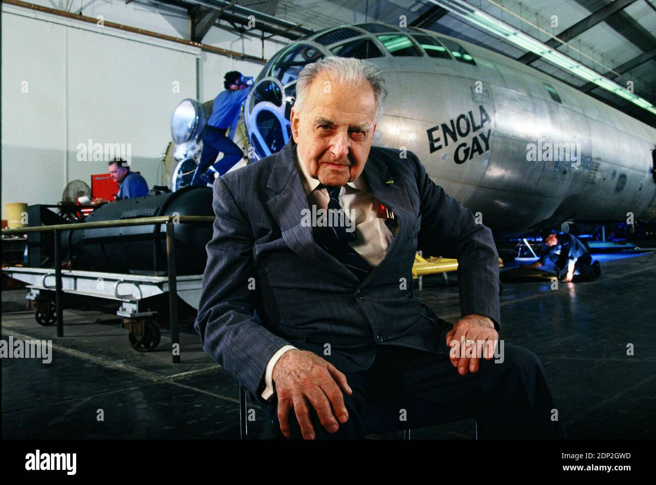 Paul Garber National Air and Space Museum poses in front of the Enola ...