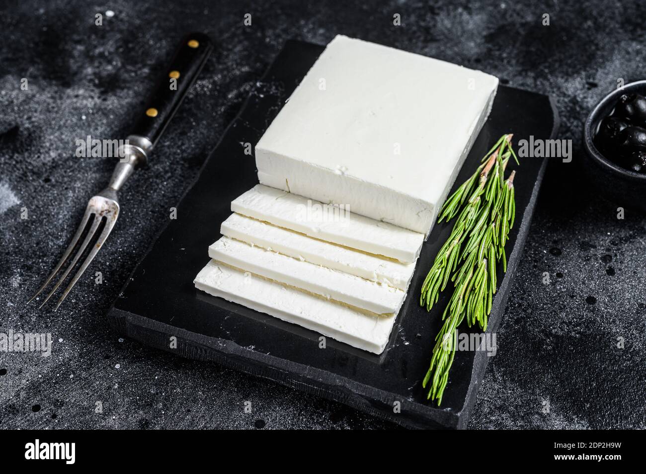 Greek cheese feta with rosemary and olives. Black background. Top view ...