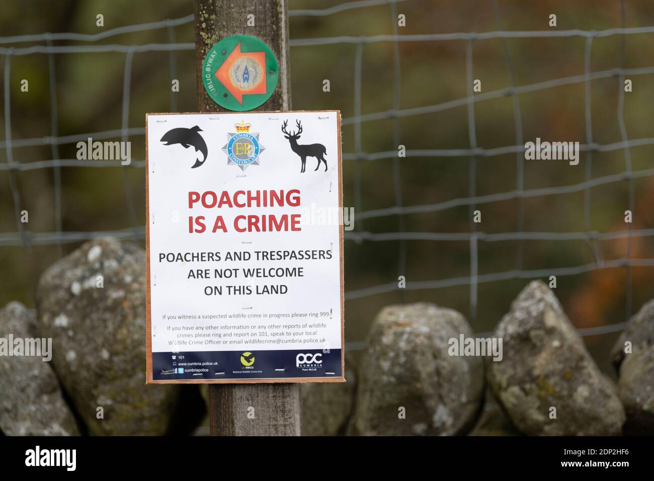 Sign on a footpath warning against poaching and trespassing on land in ...