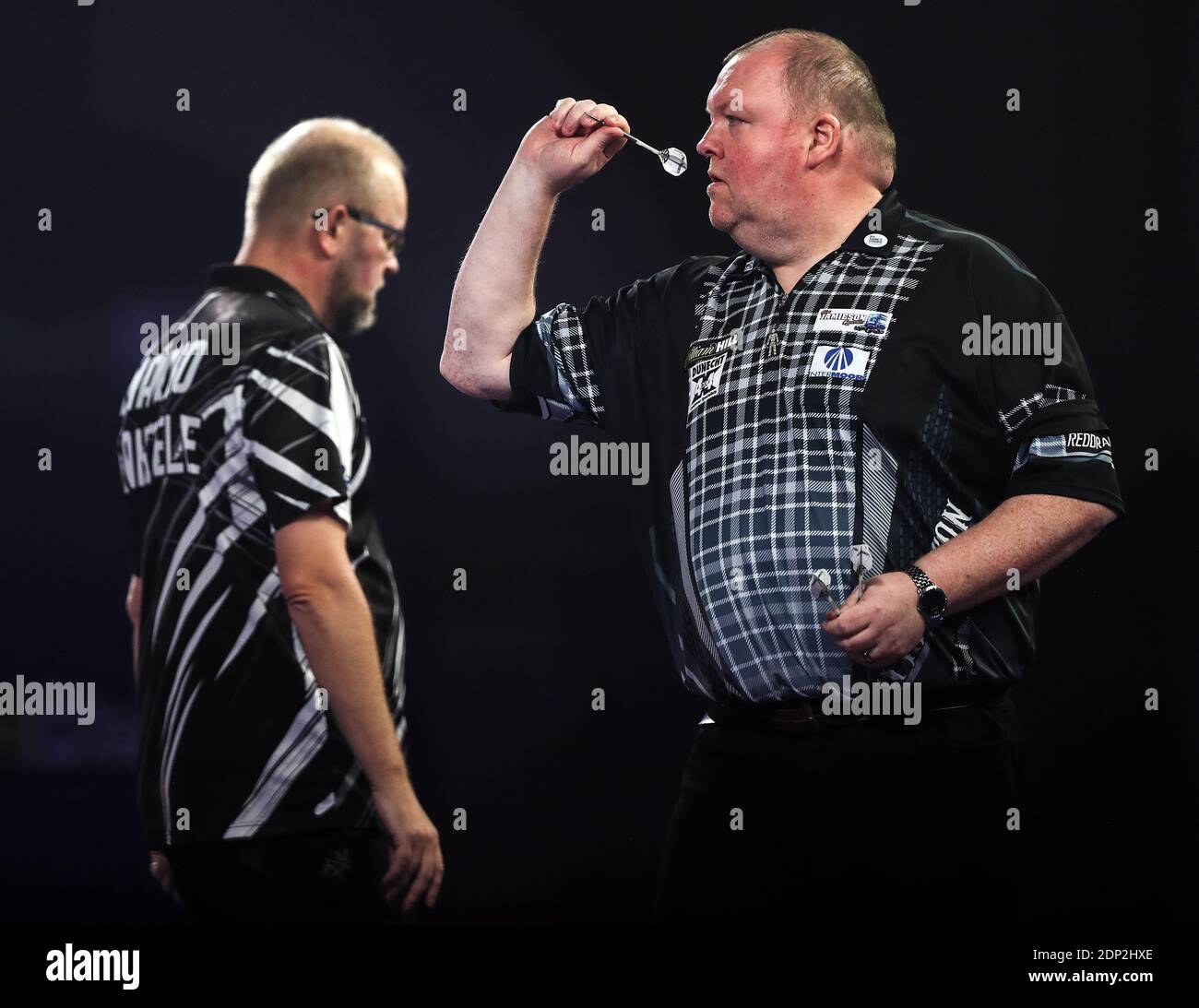 John Henderson (right) in action as Marko Kantele walks past the ache ...