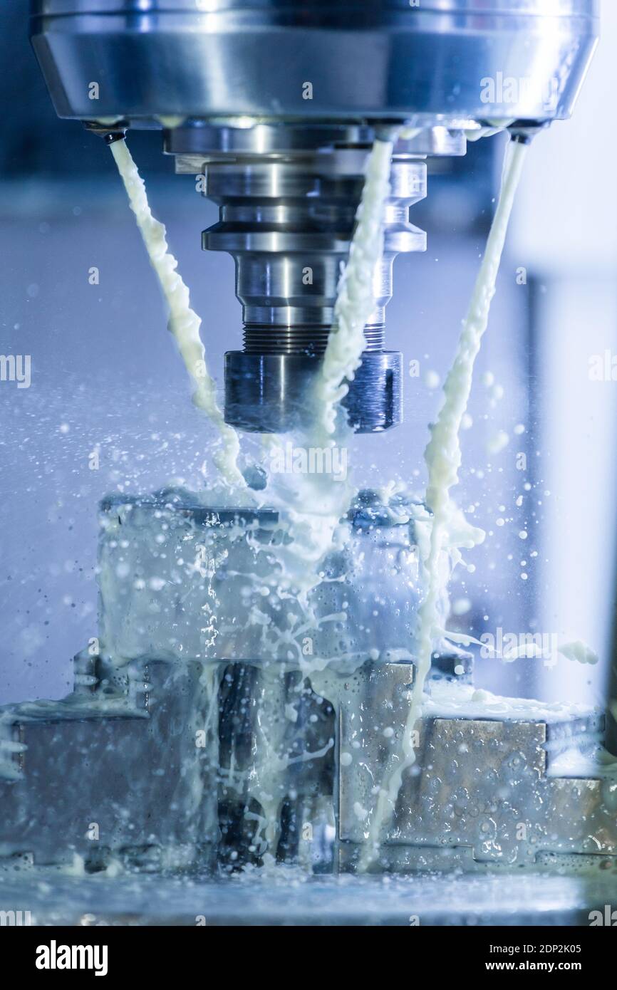 Vertical photo of industrial wet milling process in 5-axis cnc machine ...
