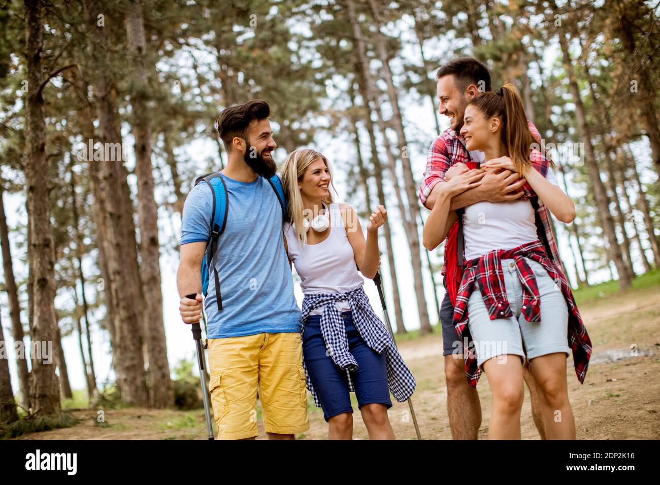 Happy young group of people hiking together through the fores Stock ...