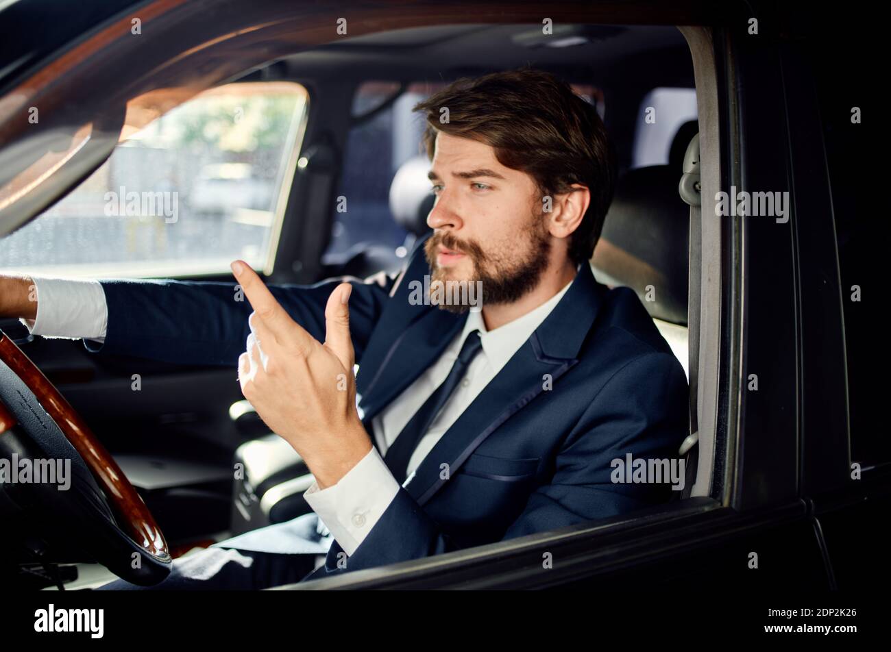 handsome man in suit driving a car trip official lifestyle Stock Photo ...