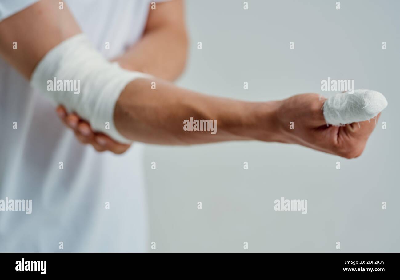 man with injured arm bandaging medicine to patient Stock Photo - Alamy