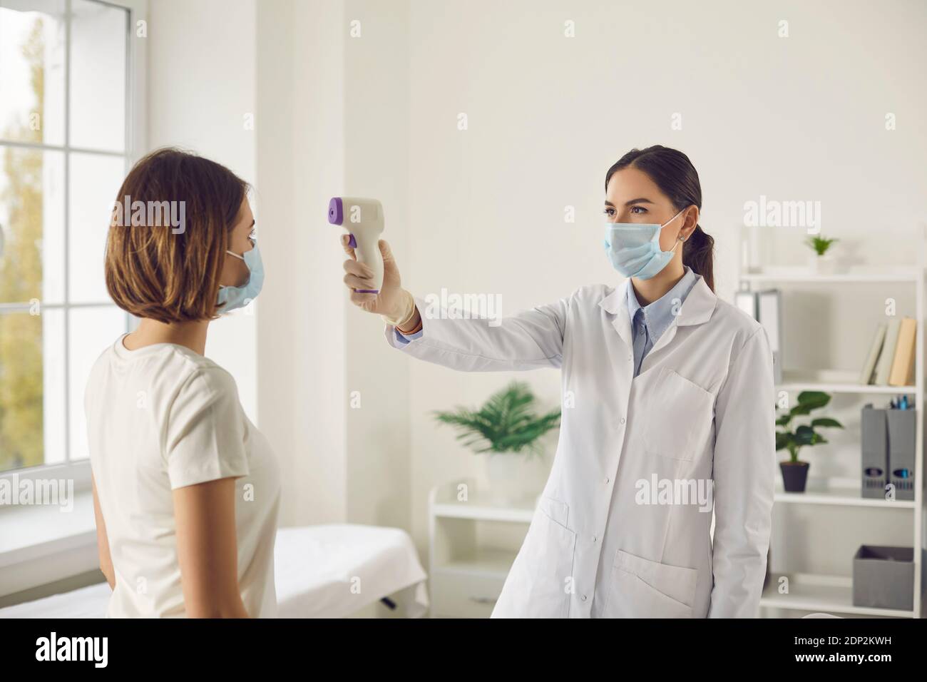 Doctor checking temperature hi-res stock photography and images - Alamy