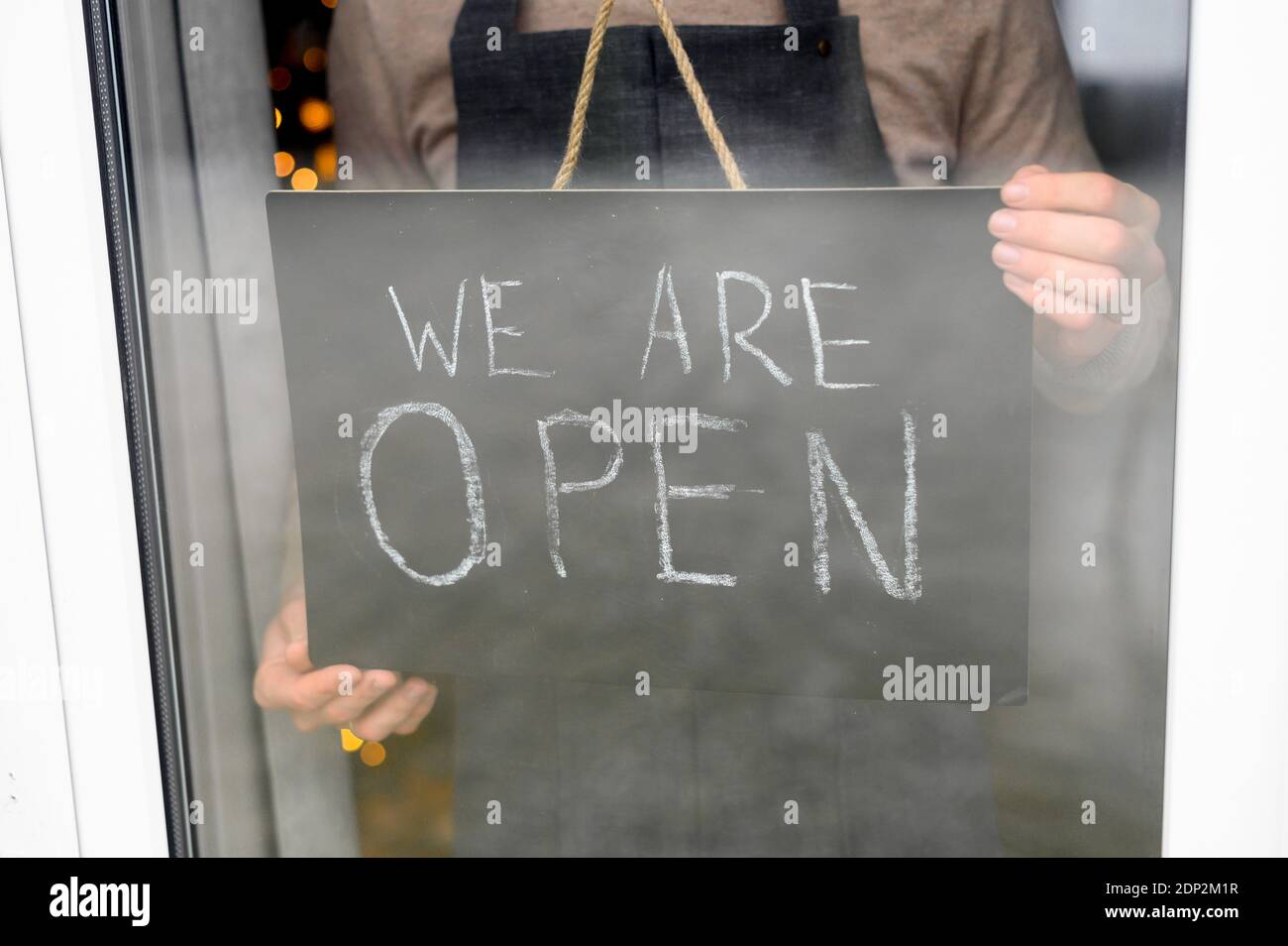 The onen sign board in barista hands Stock Photo - Alamy