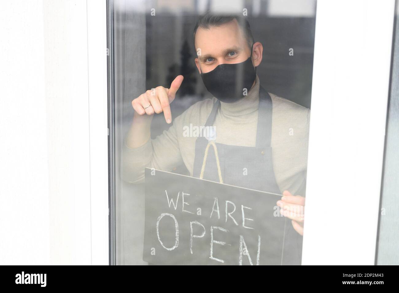 Man holding open sign hi-res stock photography and images - Alamy