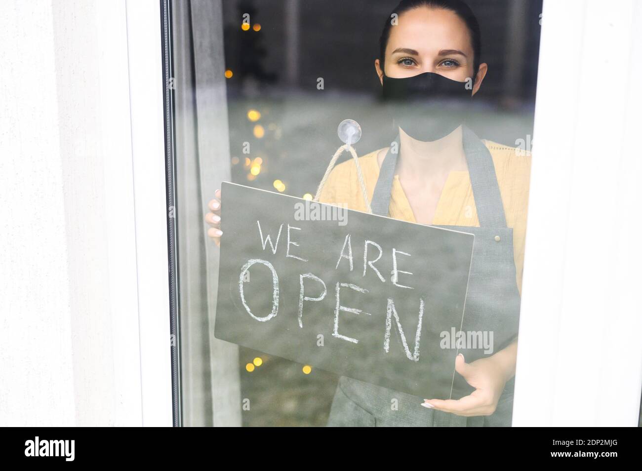 Woman turning open sign hi-res stock photography and images - Alamy