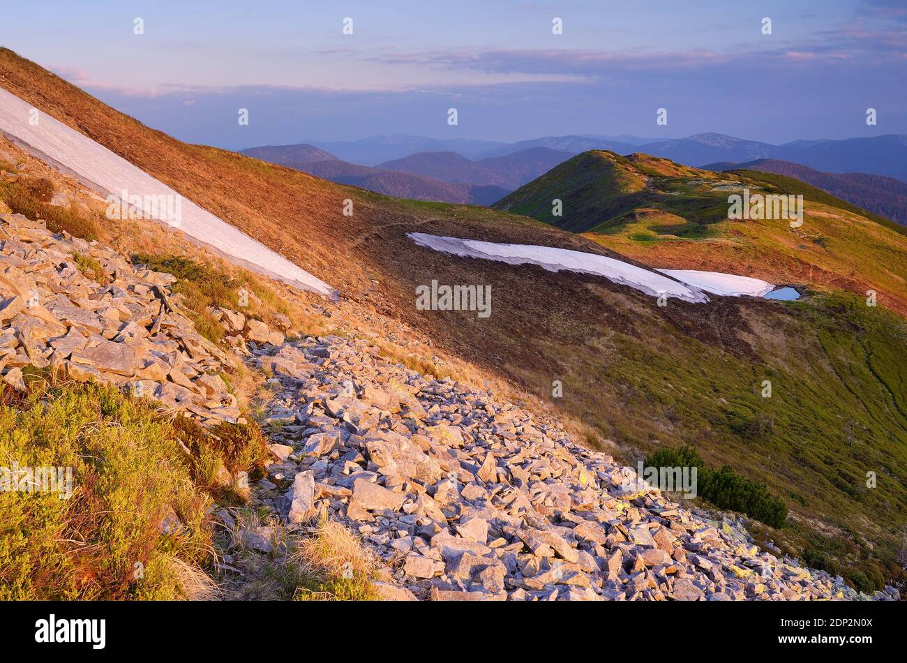 Tourist path in the mountains. Spring landscape with the last snow ...