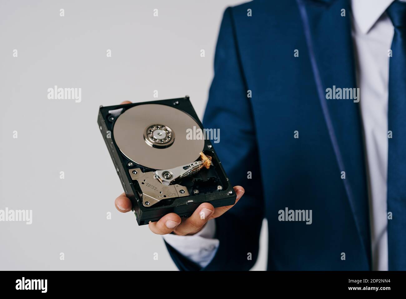 business man holding disassembled hard drive on gray background Stock ...