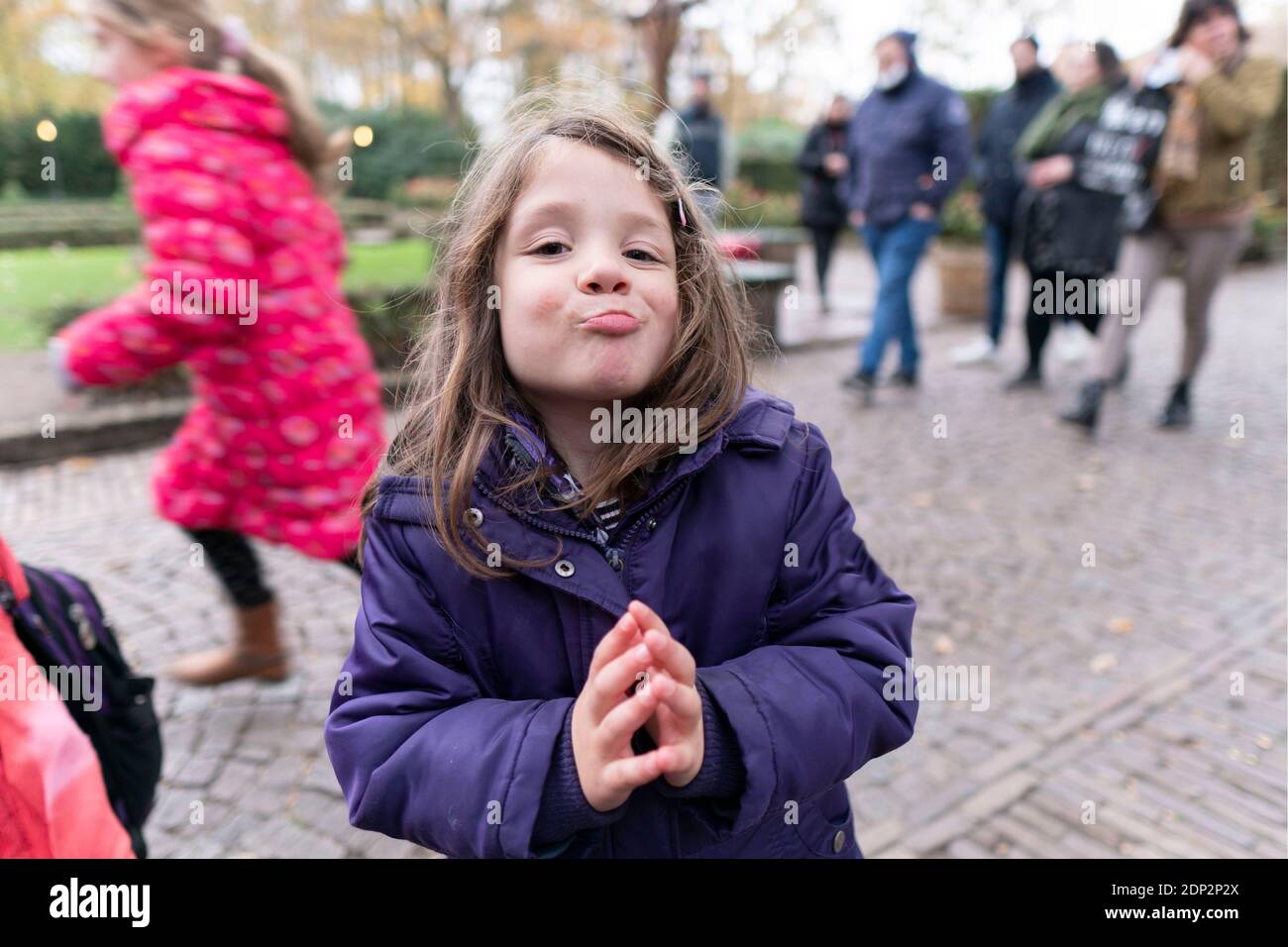 Cute girl asking permission from parents for something. Outdoor park ...