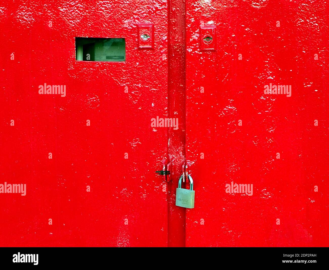 Detail of a freshly-painted red metallic box secured with a brass ...