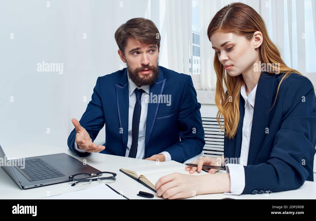 Woman in suit and man with laptop documents communication staff ...