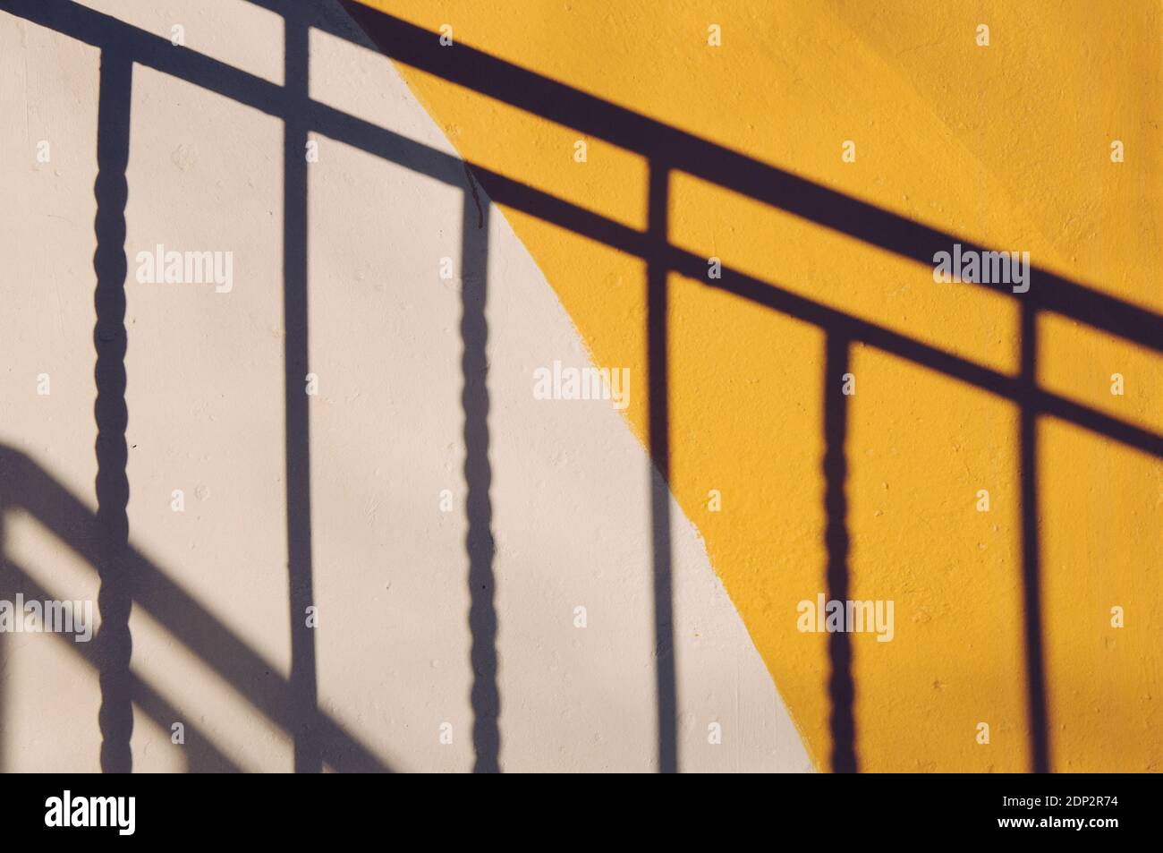 Architecture detail shadow of ladders rail yellow wall Stock Photo - Alamy