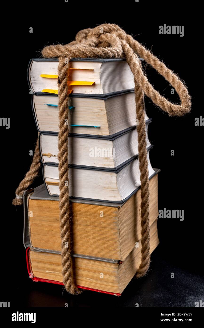 Thick books tied with a strong rope. A thick line around the paper ...