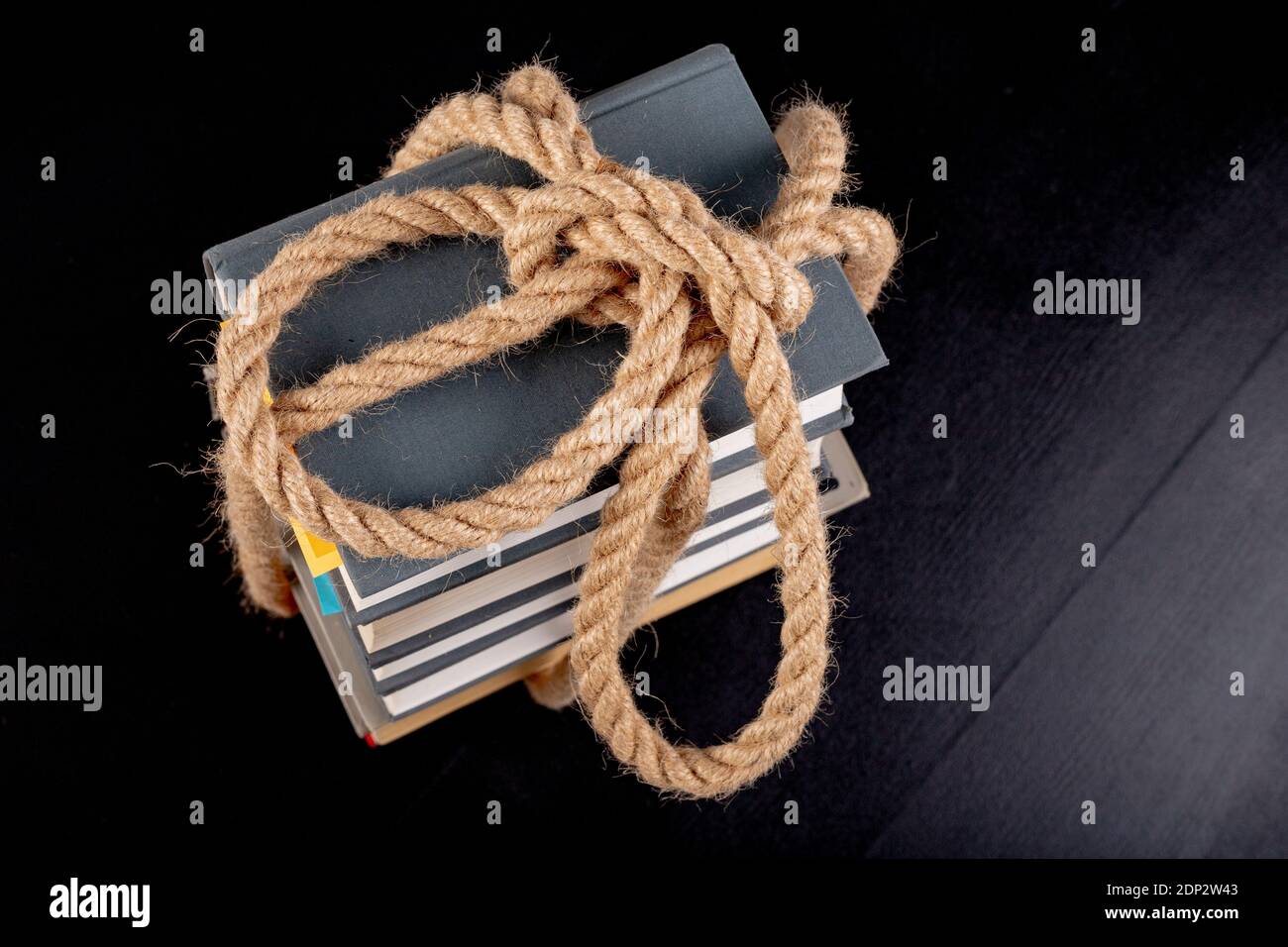 Thick books tied with a strong rope. A thick line around the paper ...