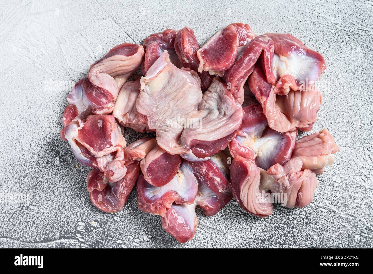Raw uncooked chicken gizzards, stomach. Gray background. Top view Stock ...