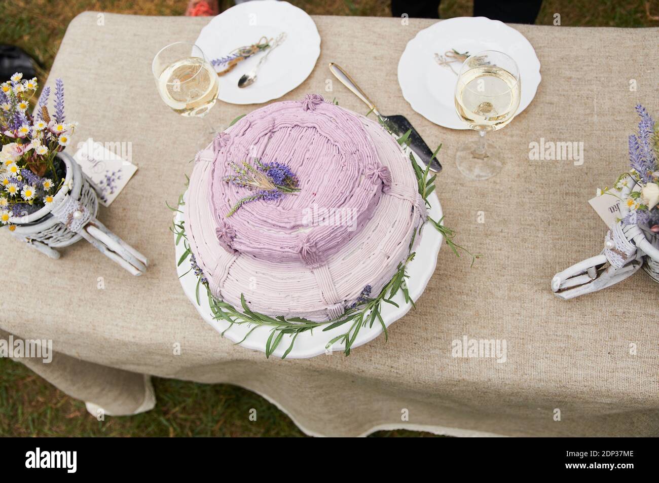 boho style wedding cake on a table covered with a linen tablecloth ...
